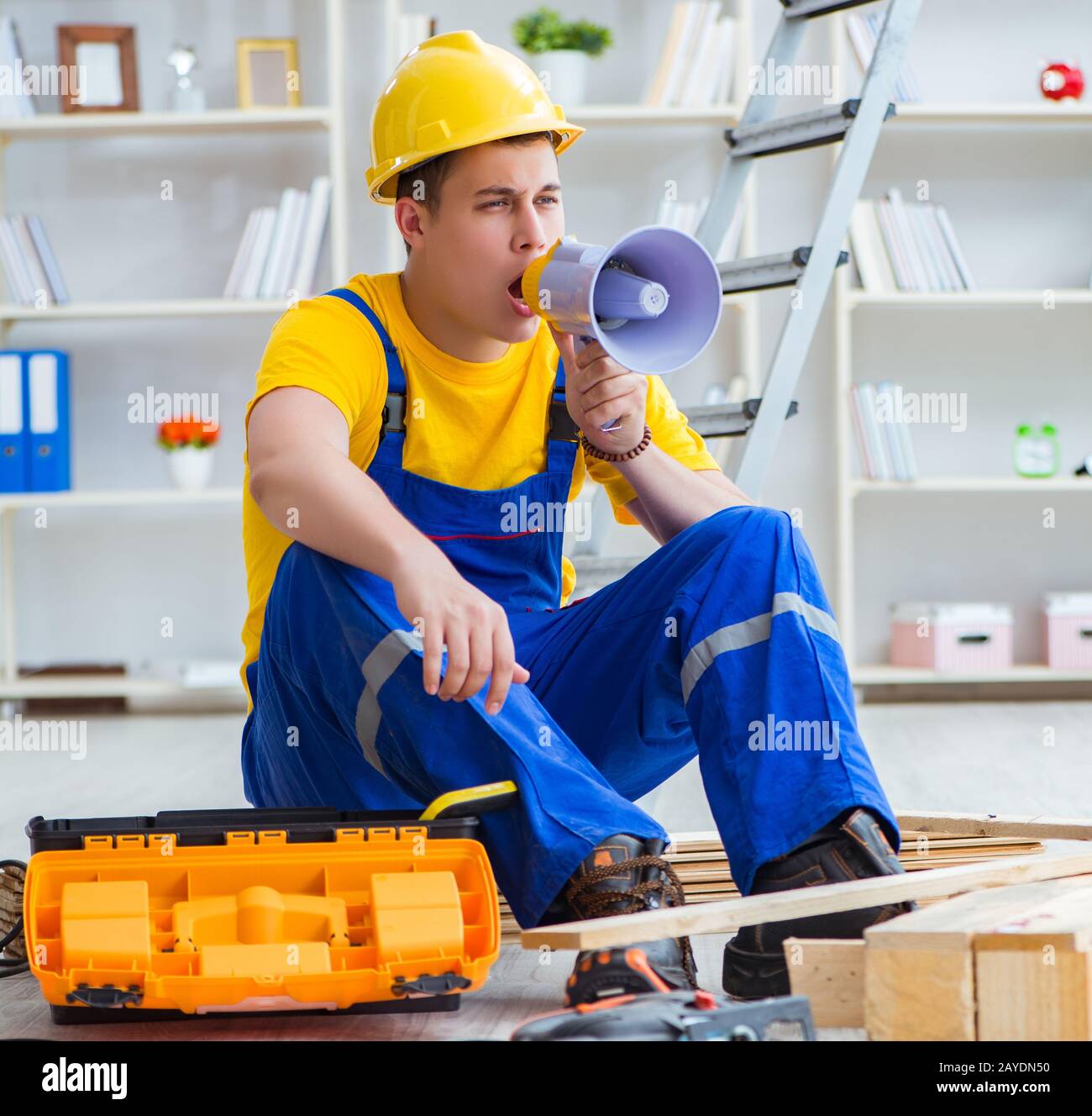 Young man assembling wood pallet Stock Photo - Alamy