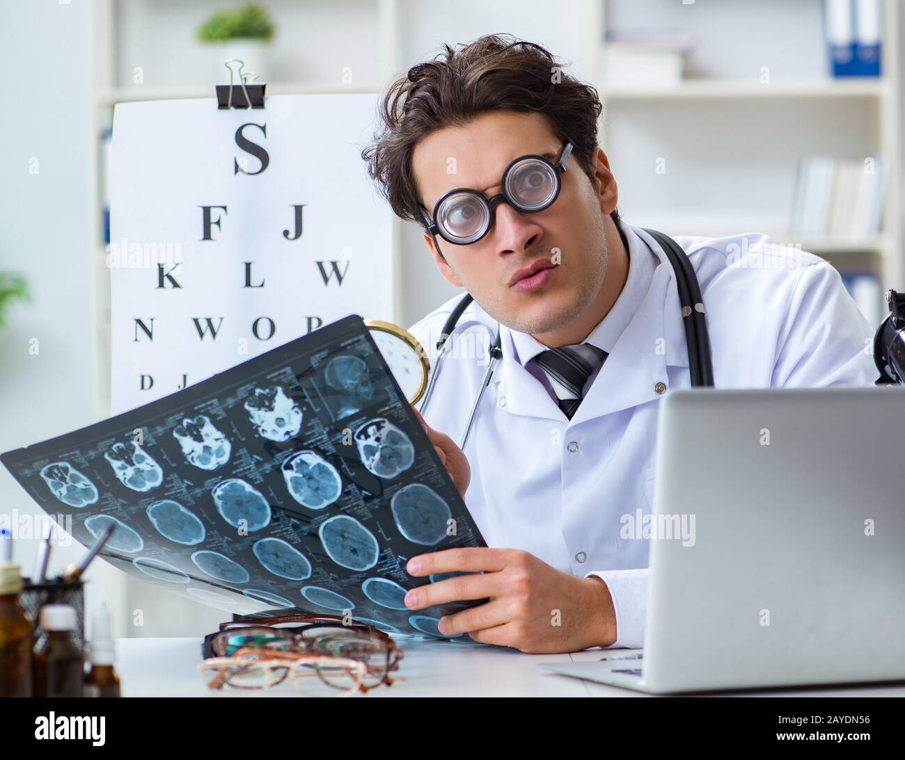 Funny eye doctor in humourous medical concept Stock Photo - Alamy
