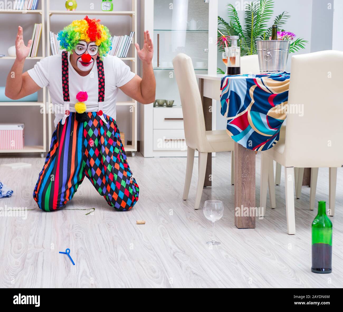 Drunk clown celebrating having a party at home Stock Photo - Alamy