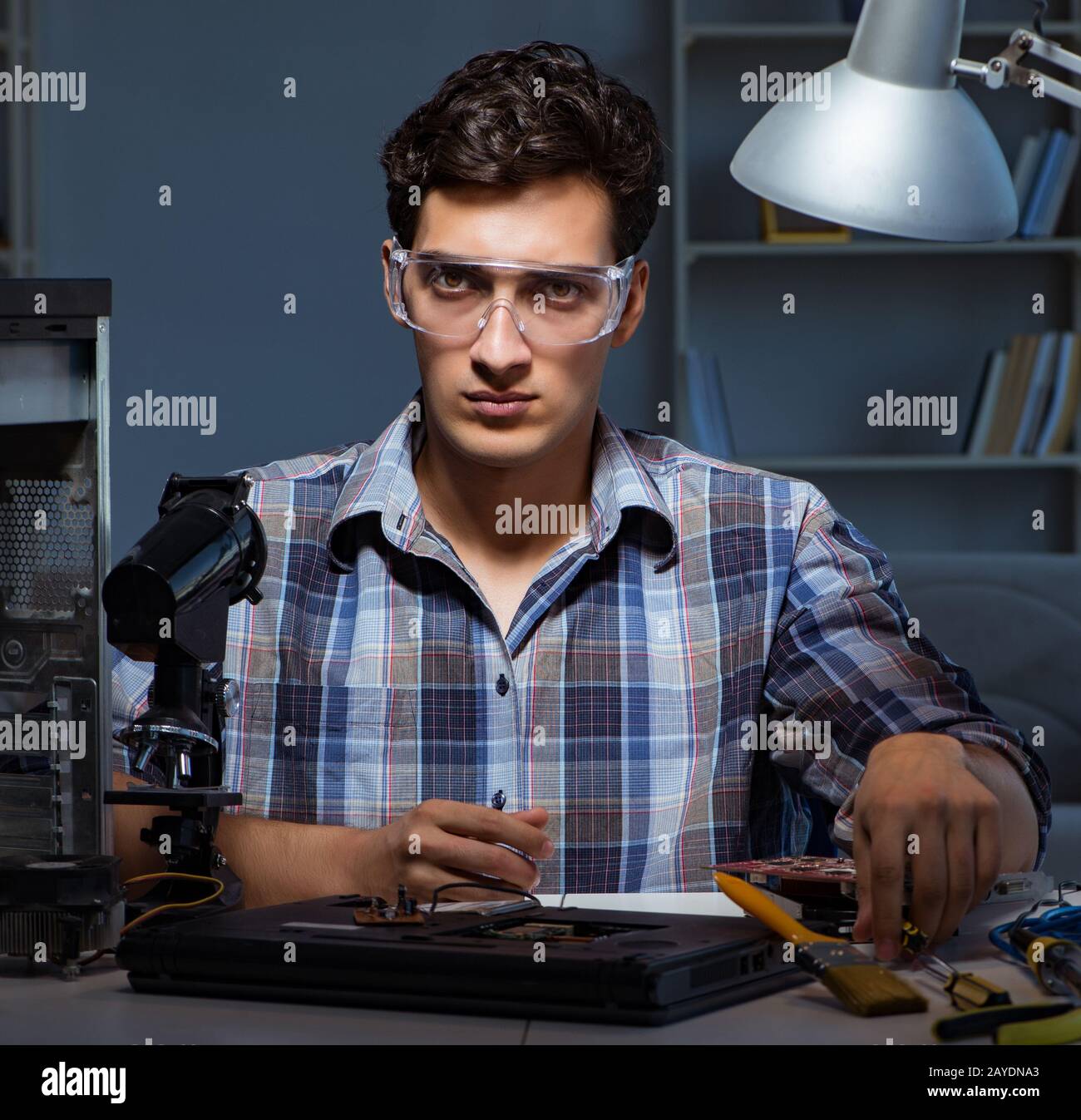 The computer repair man cleaning dust with brush Stock Photo - Alamy