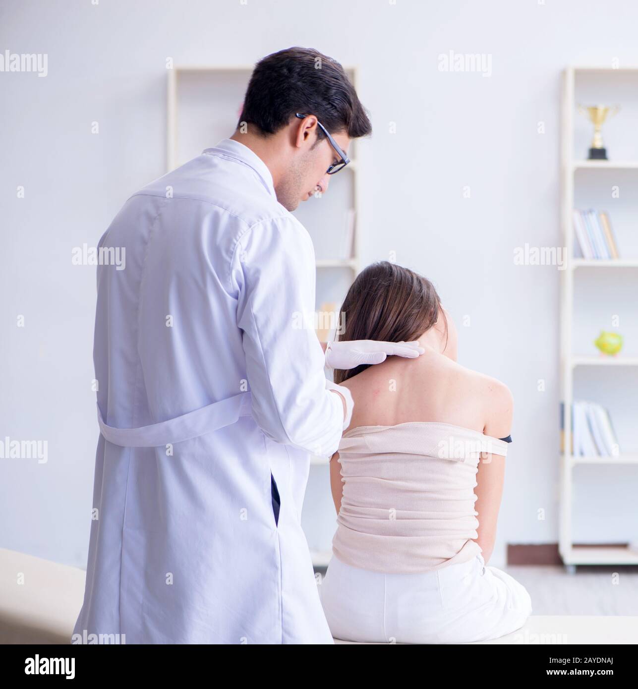 Doctor examining the skin of female patient Stock Photo - Alamy