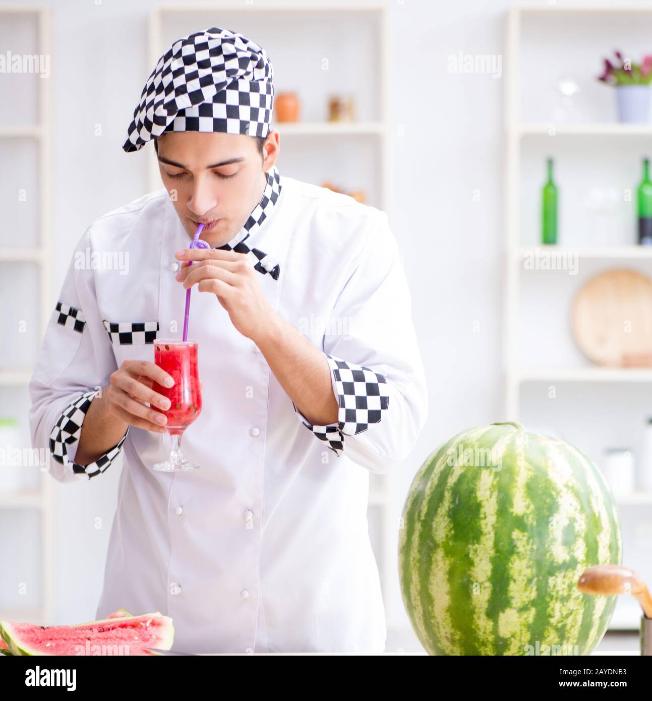 Male cook with watermelon in kitchen Stock Photo - Alamy