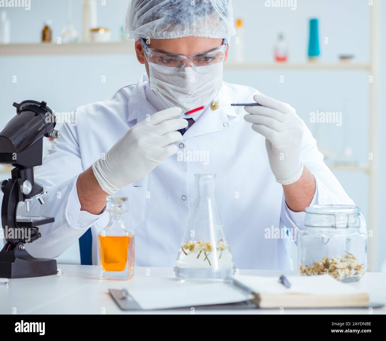 Chemist mixing perfumes in the lab Stock Photo - Alamy