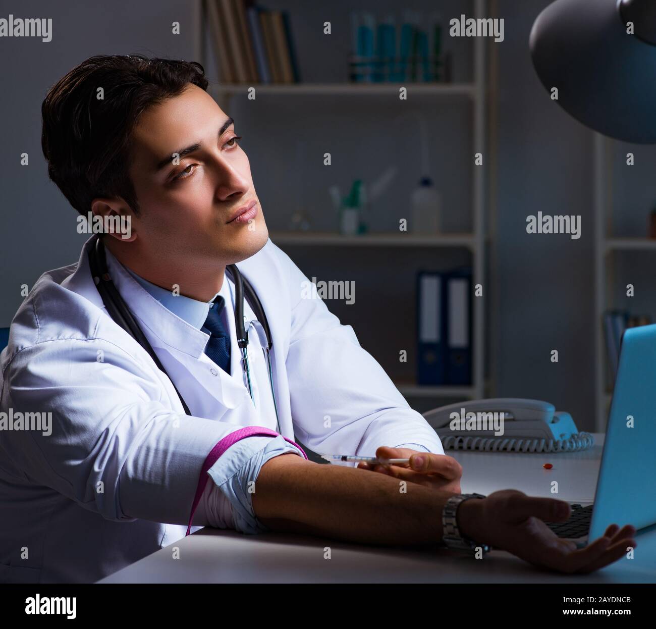 Doctor drug addict staying late on hospital Stock Photo - Alamy