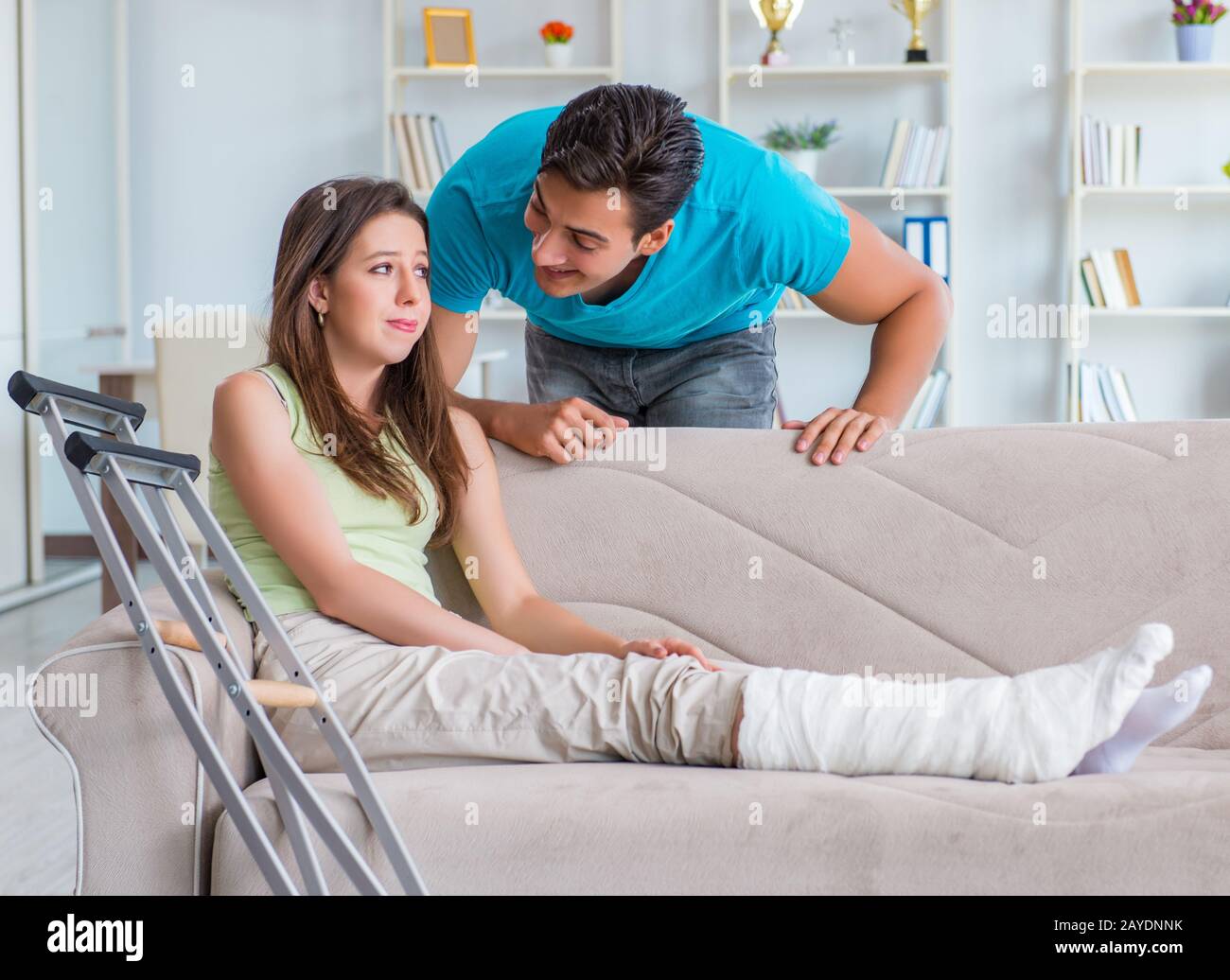 Husband man supporting injured wife Stock Photo - Alamy