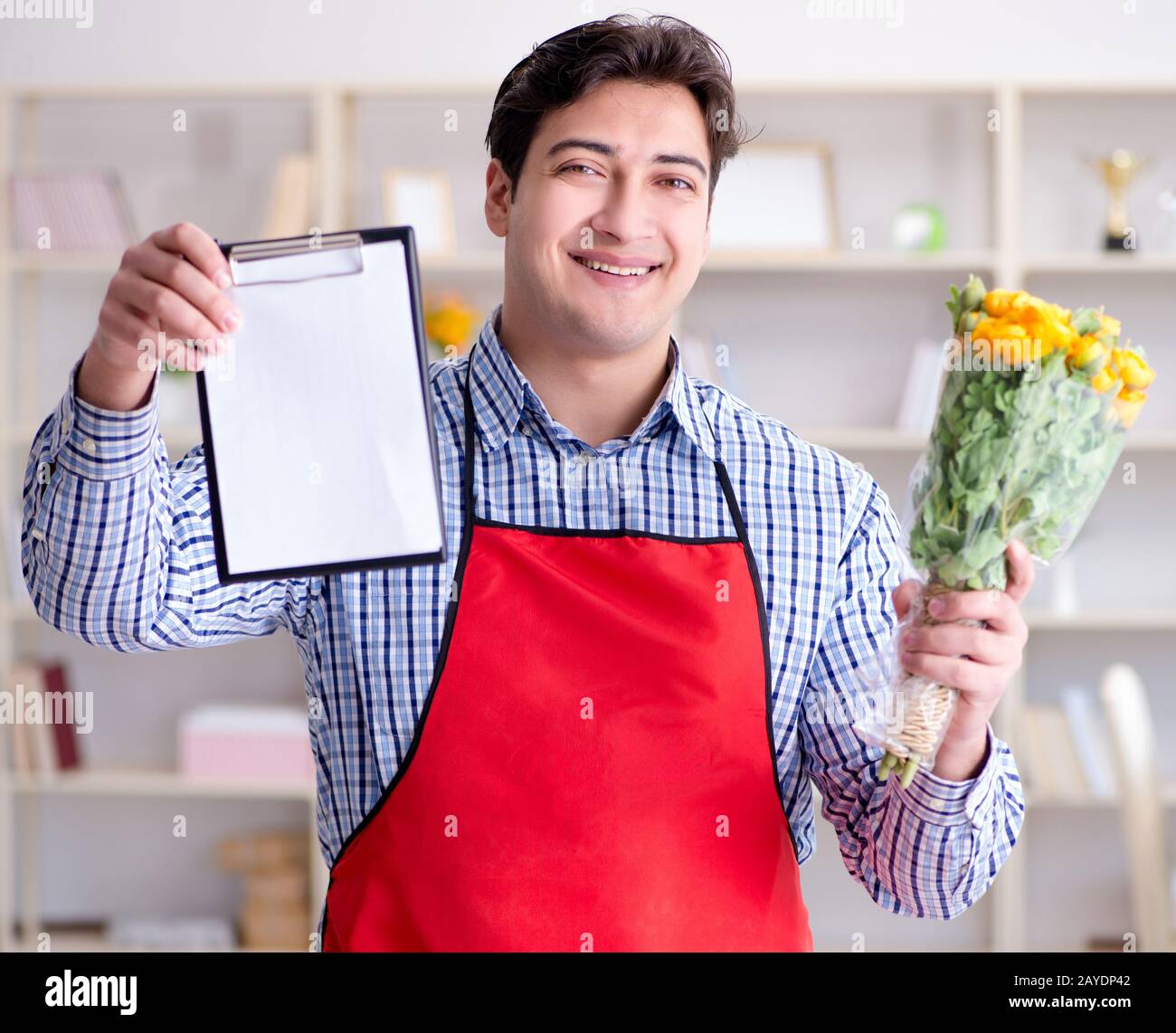 Flower shop assistant offering a bunch of flowers Stock Photo - Alamy