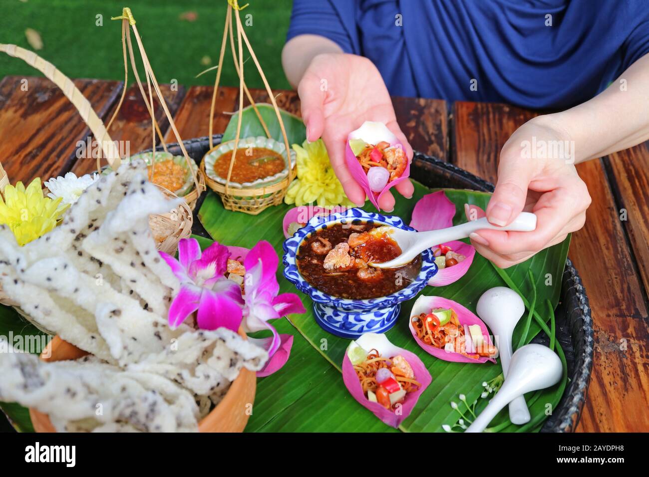 Woman's Hand Holding Fresh Lotus Petal Wrapped Appetizer while Scooping ...