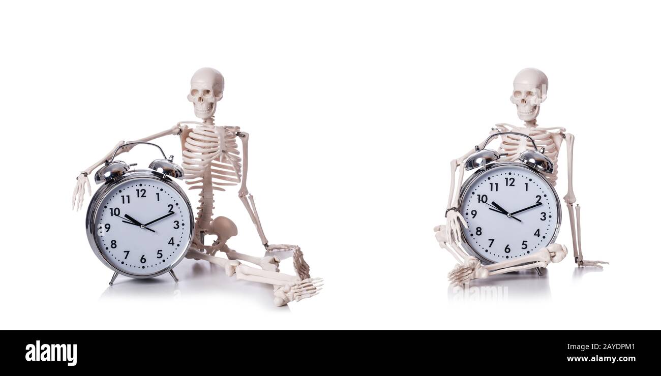 Skeleton with alarm clock on the white Stock Photo - Alamy
