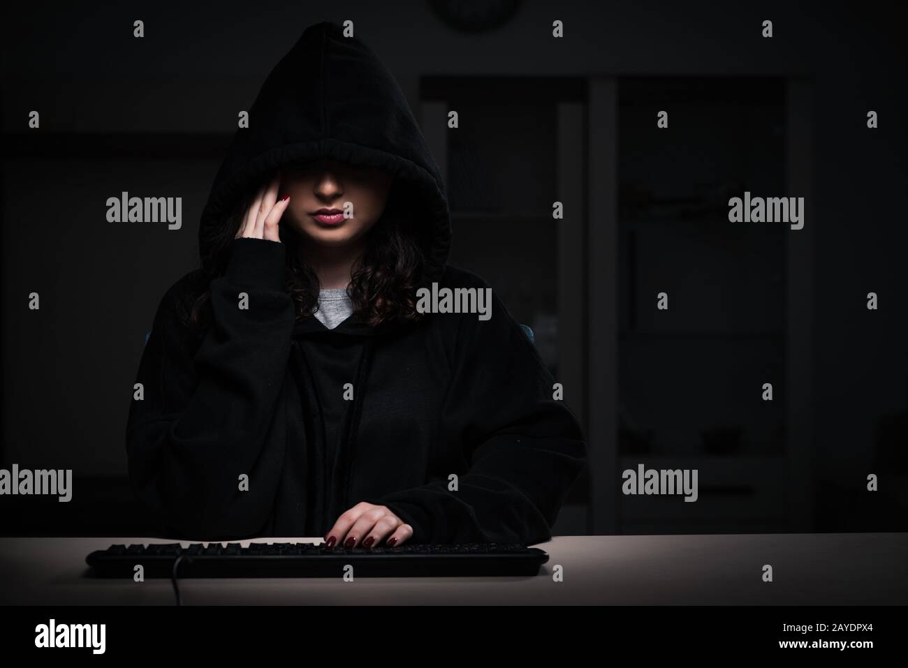 Female hacker hacking security firewall late in office Stock Photo - Alamy