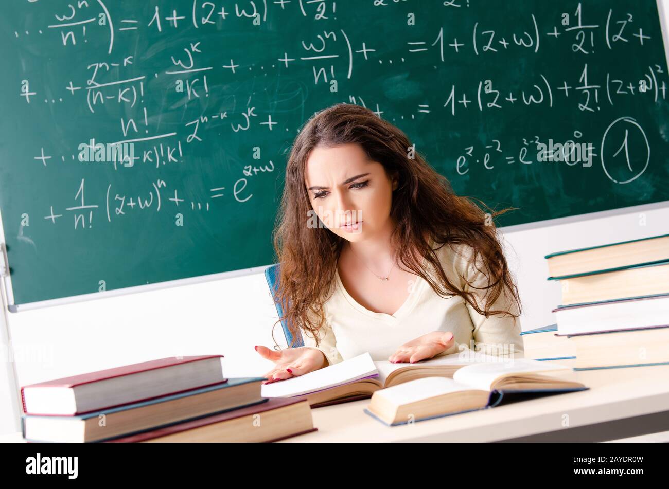Young female math teacher in front of chalkboard Stock Photo - Alamy