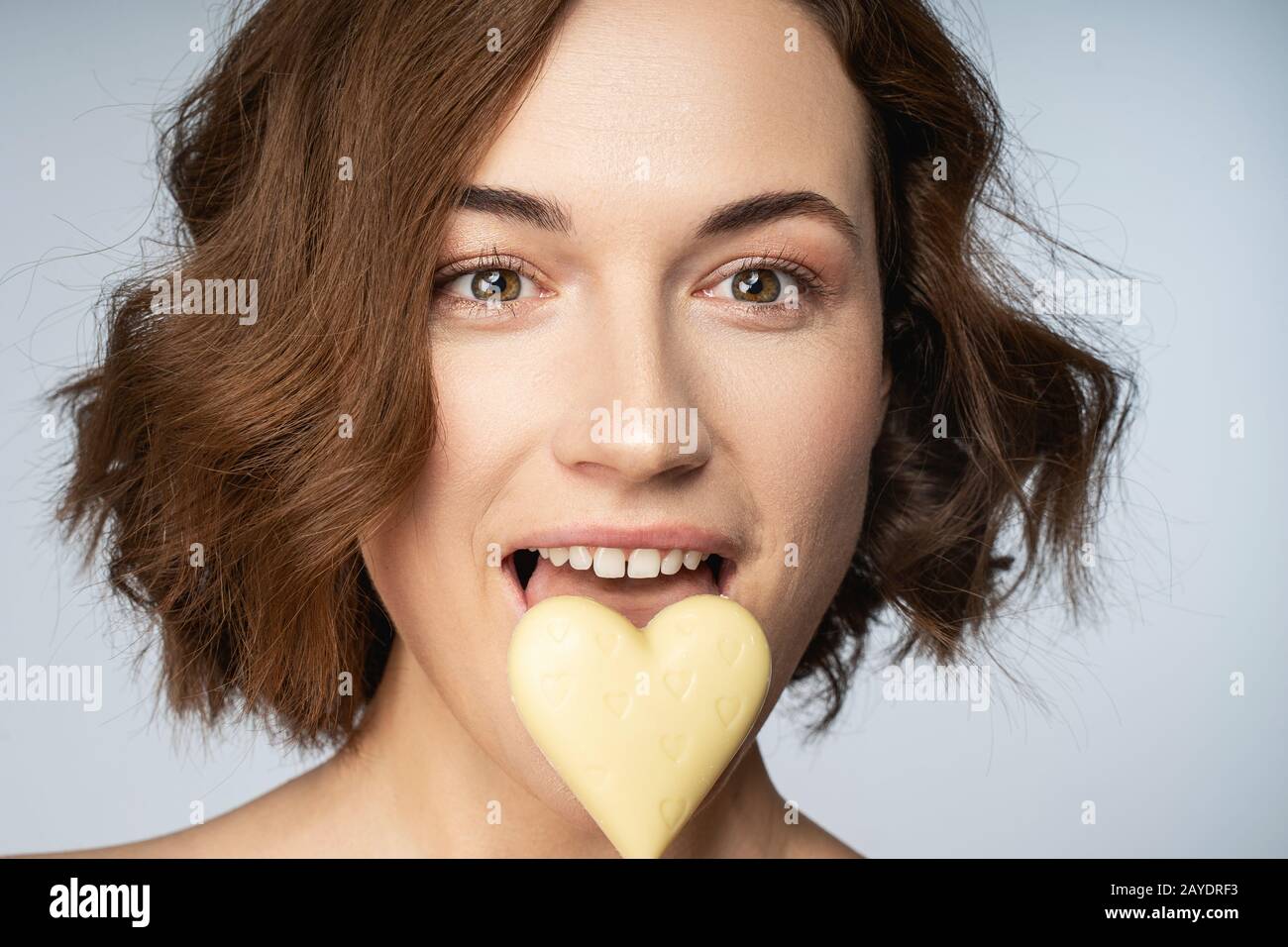 Amazing brunette female person eating chocolate candy Stock Photo - Alamy