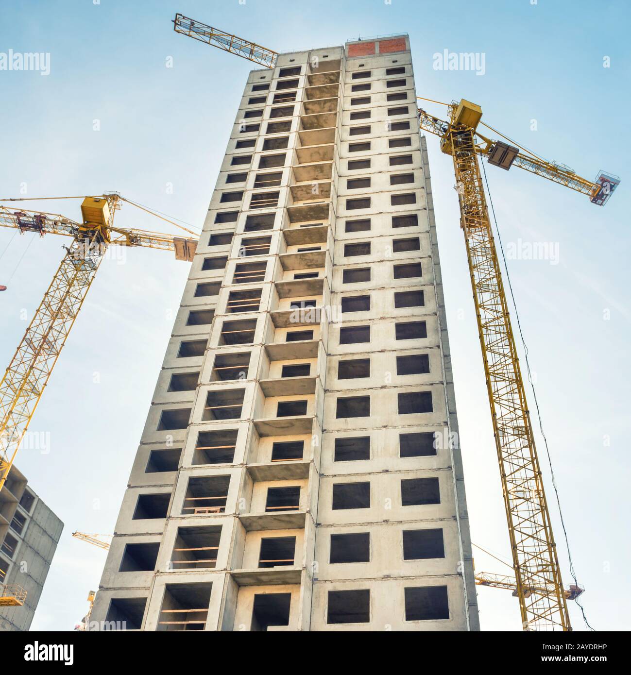 Construction site with incomplete buildings and cranes hi-res stock ...