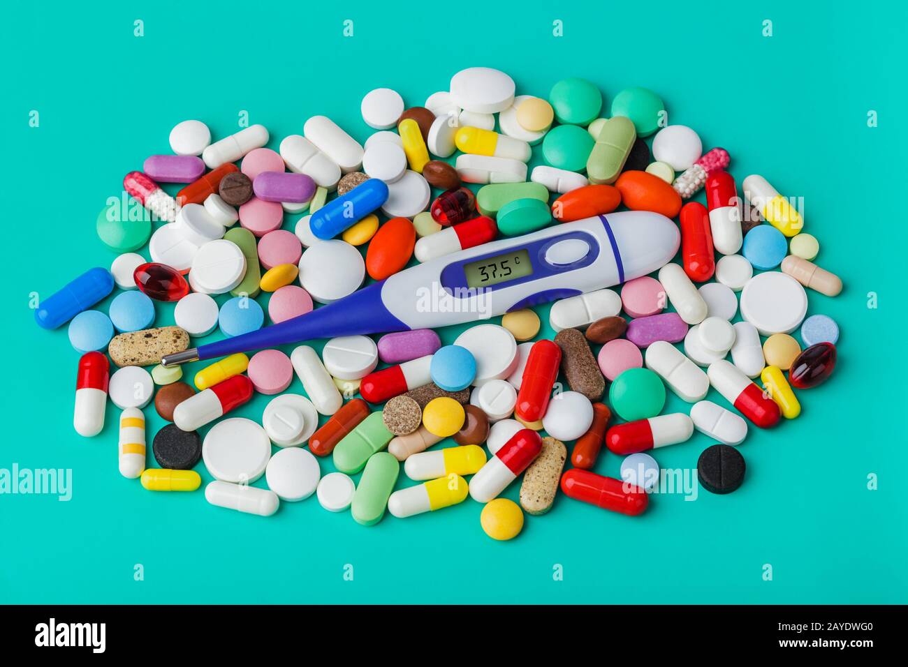 Pills and electronic thermometer (37.5 degrees) - medical background ...