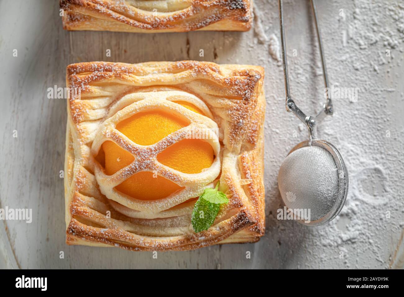 Yummy puff pastry made of fresh peaches and sugar Stock Photo - Alamy