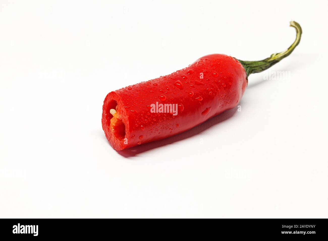 a half red chili fruit with water splash on white background Stock ...