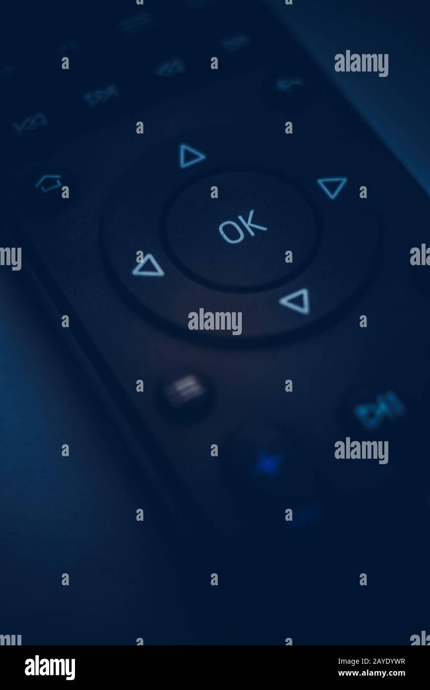 Remote control close-up. Dark blue tone. Focus on the center Stock ...