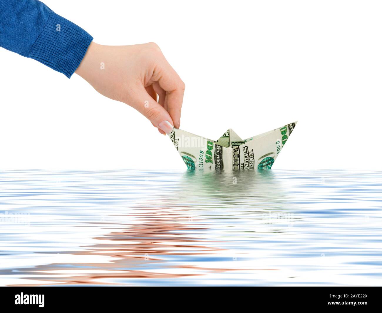 Hand launching money ship Stock Photo - Alamy