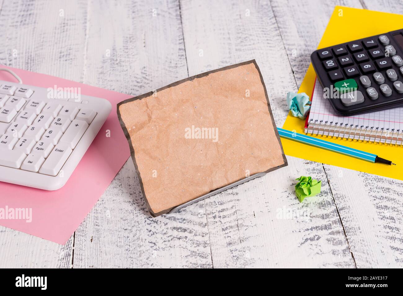 Notepaper in brown colour standing on a buffer wire in between a ...