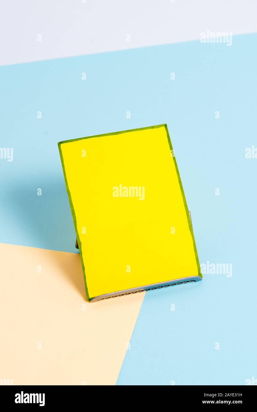 Paper sheet placed tilted on a buffer wire with a soft pastel backdrop ...