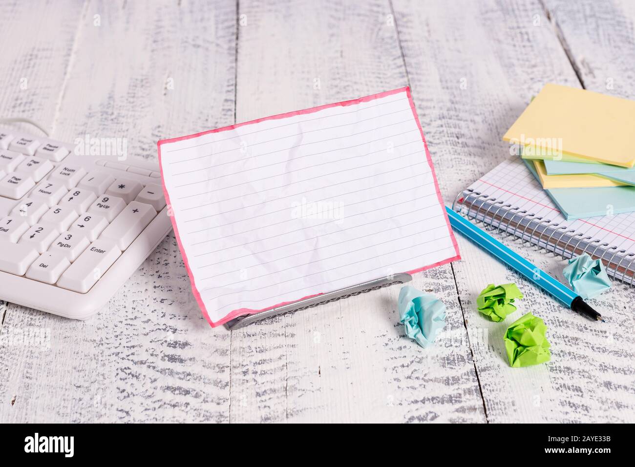 Notepaper in white colour standing on a buffer wire in between a ...