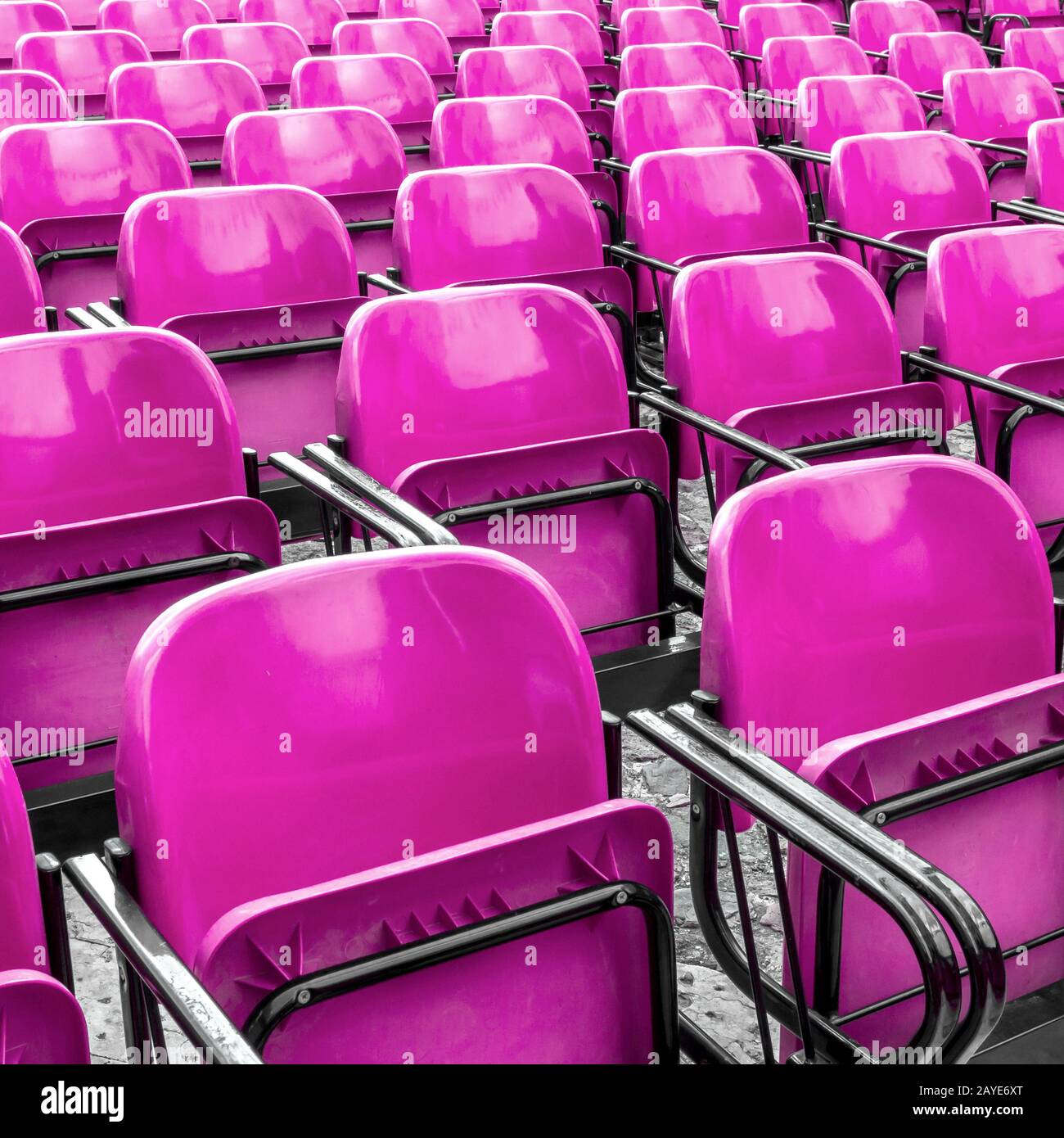 Empty plastic pink chairs Stock Photo - Alamy