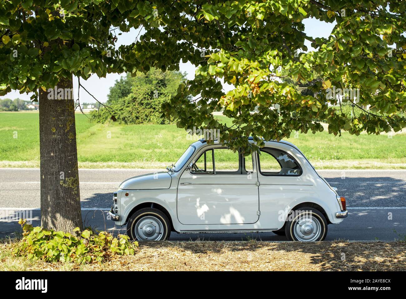 White small vintage car on the street. No people Stock Photo - Alamy