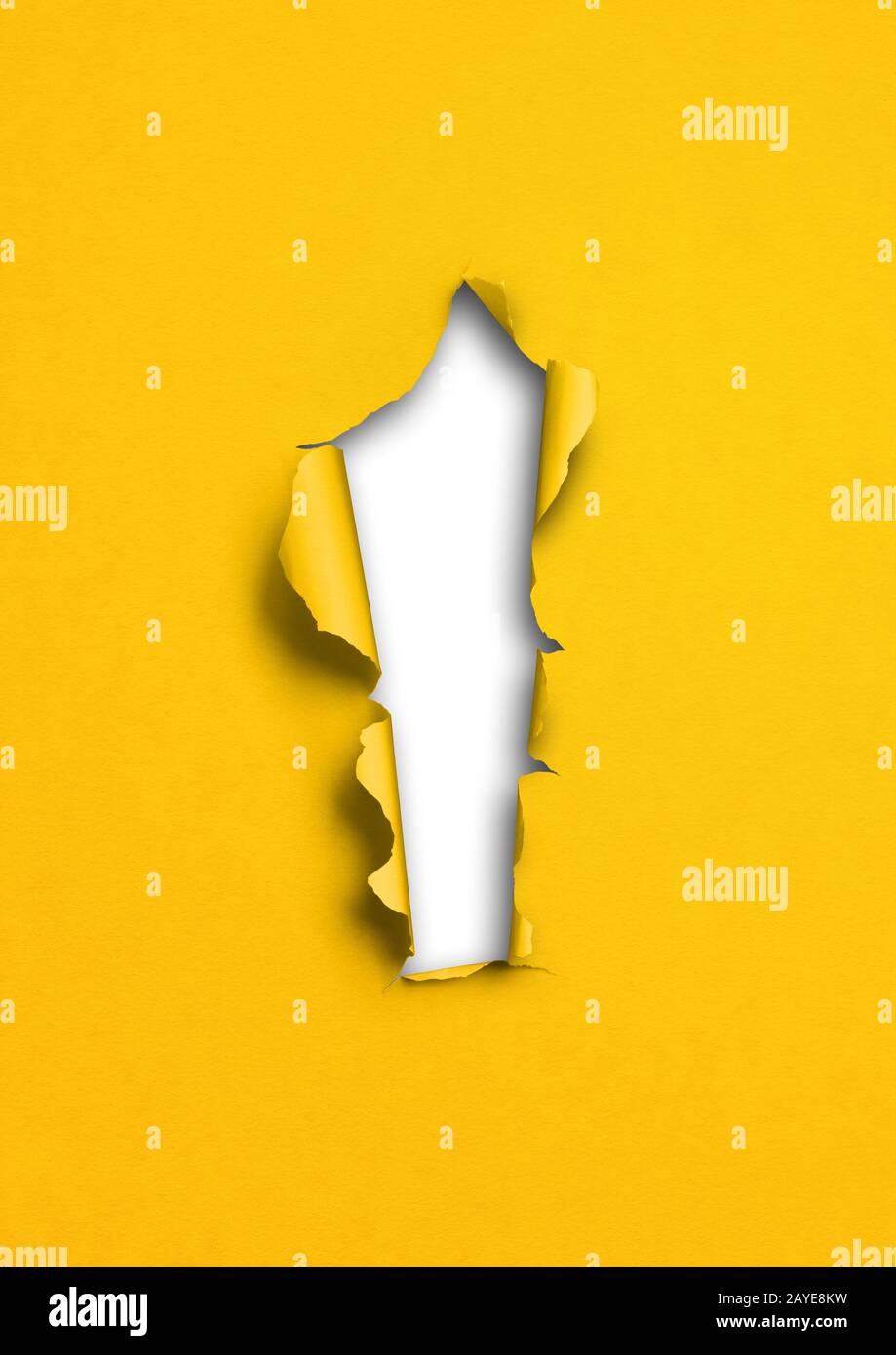 Yellow torn paper with hole Stock Photo - Alamy