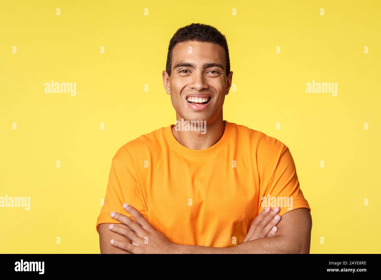 Joyful smiling handsome masculine man in t-shirt, cross arms chest ...