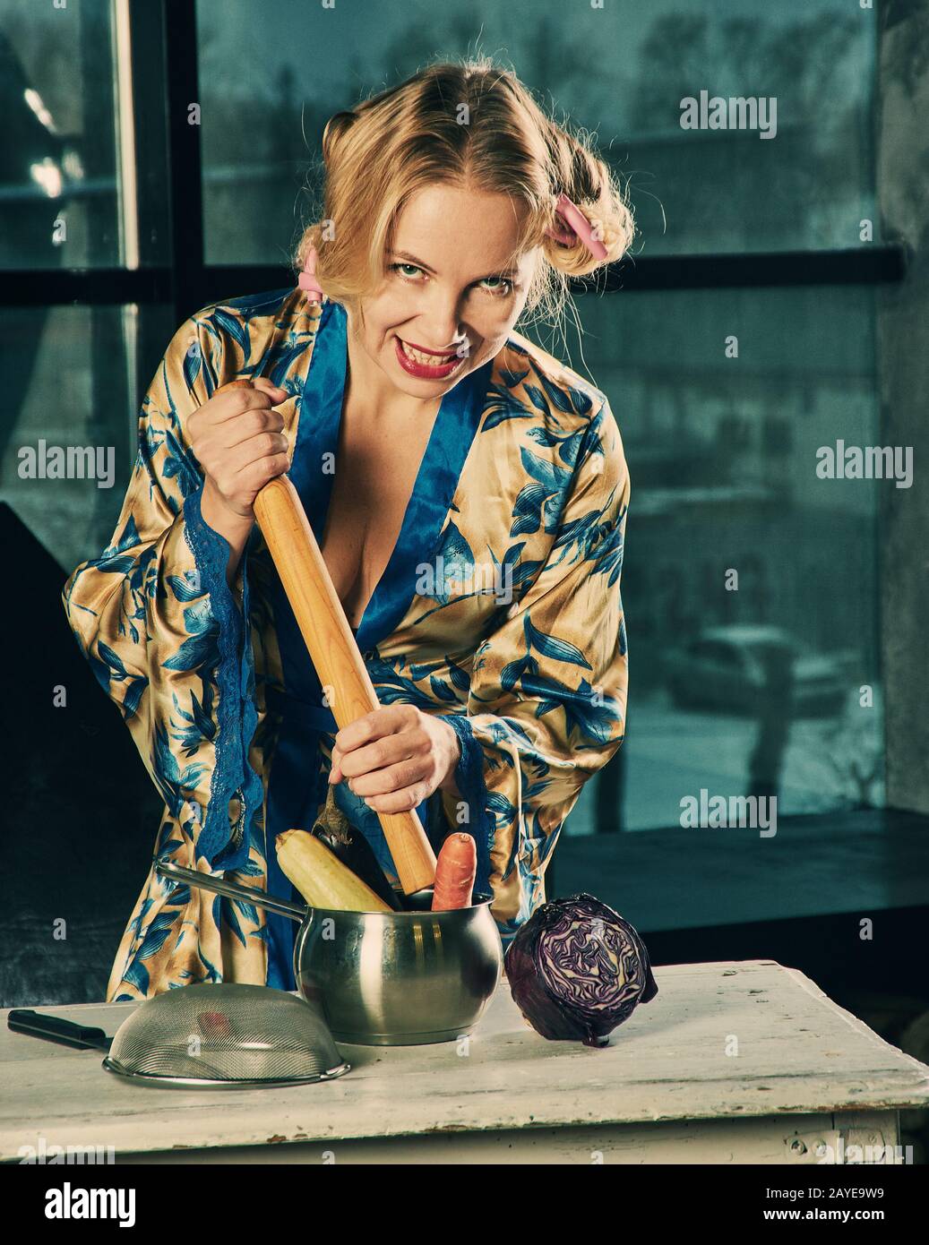 Aggressive housewife in the kitchen preparing dinner Stock Photo - Alamy
