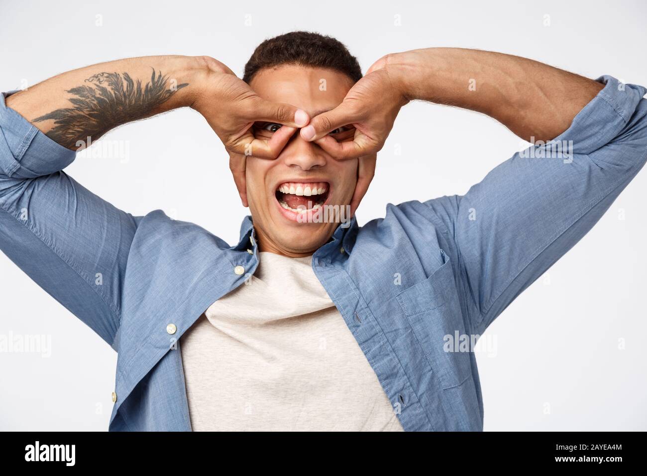 Cheerful and carefree funny handsome man, fooling around, mimicking ...