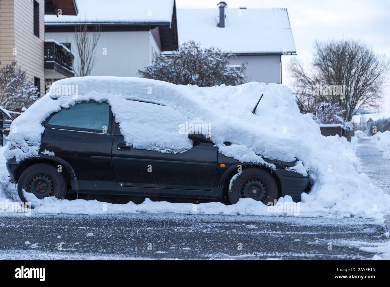 Parking car is snowed in - winter Stock Photo - Alamy
