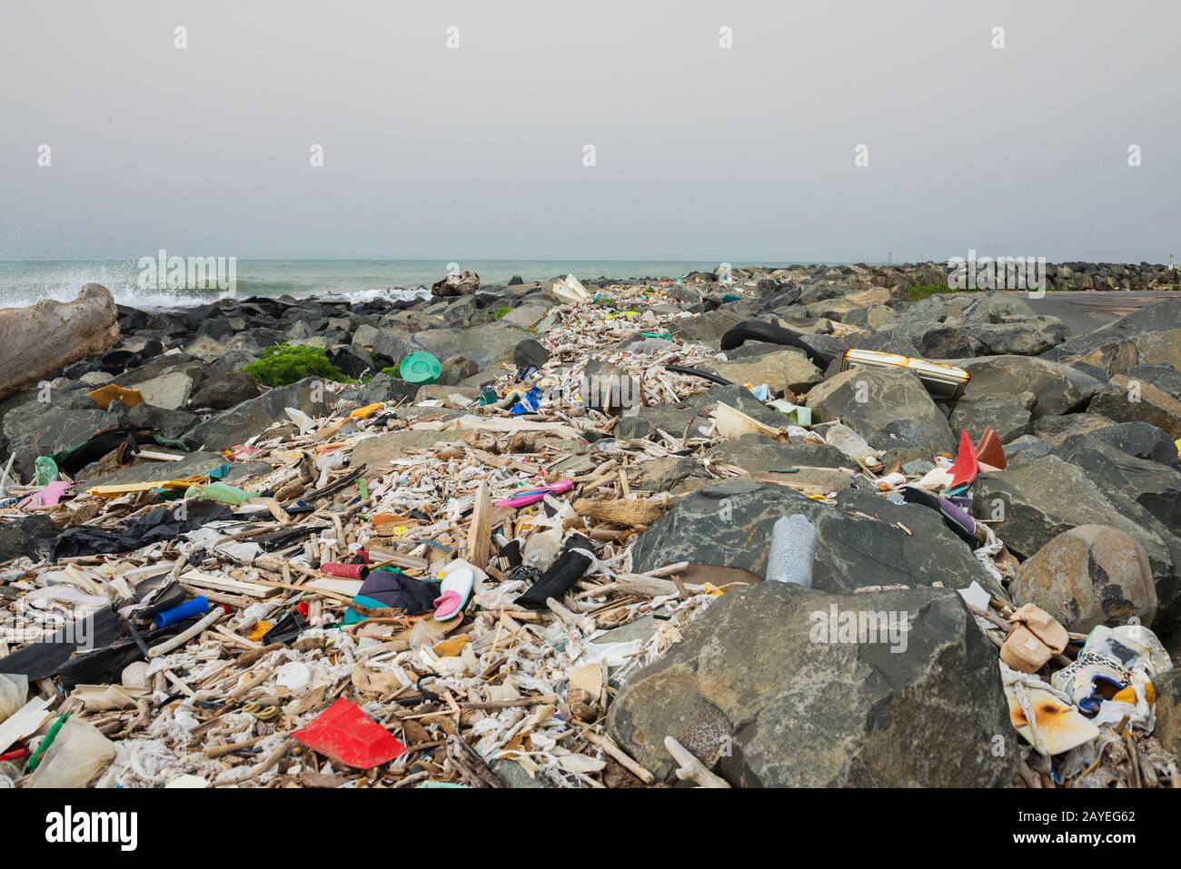 Spilled garbage on the beach near the big city. Empty used dirty ...