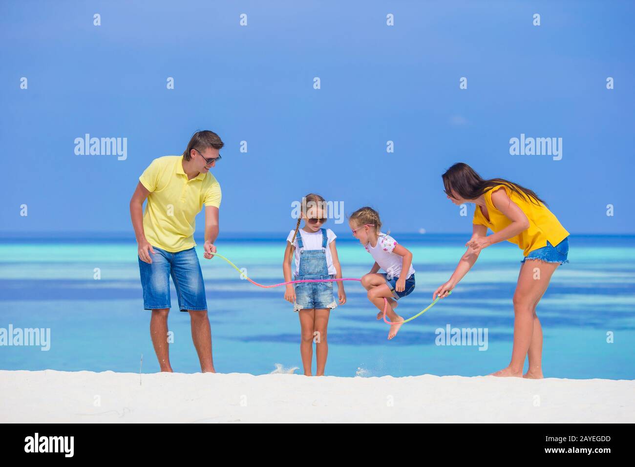 Happy family on beach playing hi-res stock photography and images - Alamy