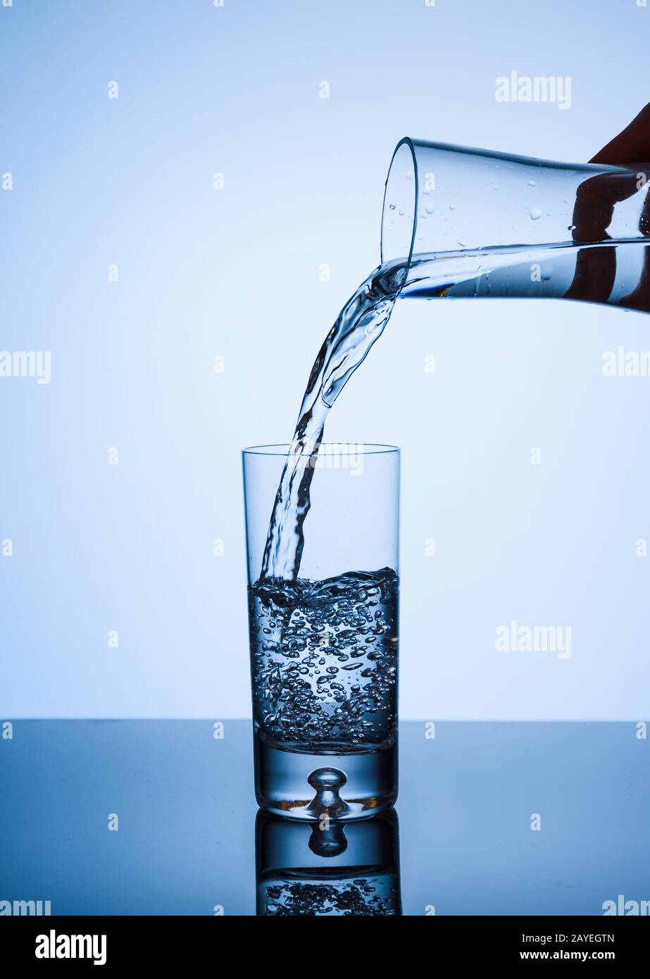 Pouring drinking water from a pitcher into a glass. Clean drinkable ...