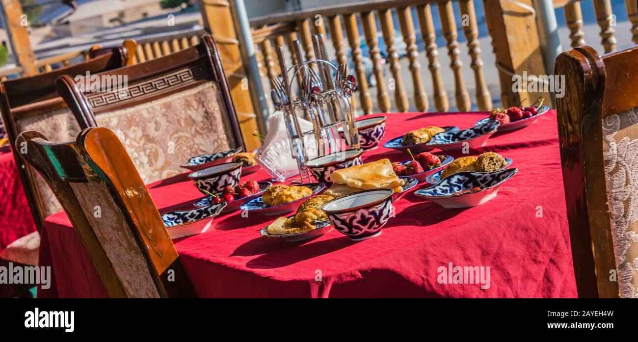 Traditional Uzbek breakfast served on the terrace Stock Photo - Alamy
