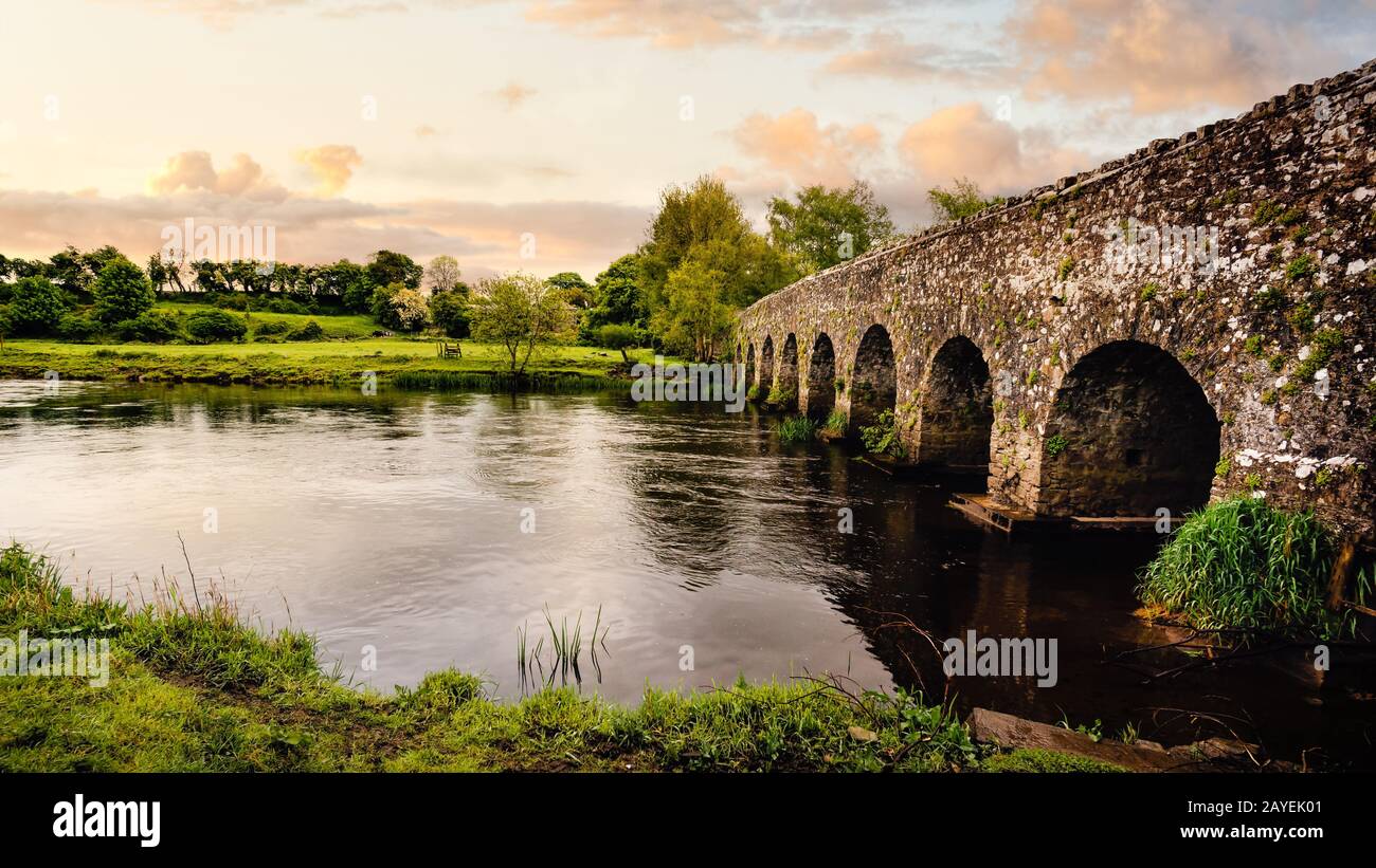 Old 12th century stone arch bridge over a river. Count Meath, Ireland ...