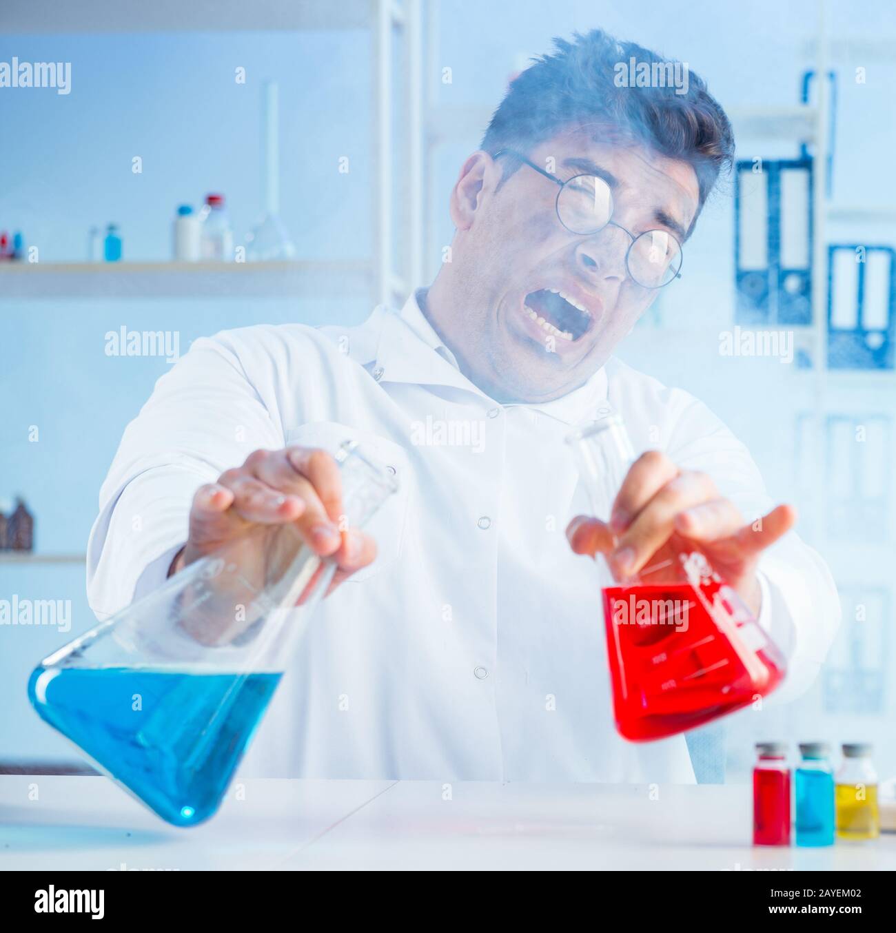 Funny mad chemist working in a laboratory Stock Photo - Alamy
