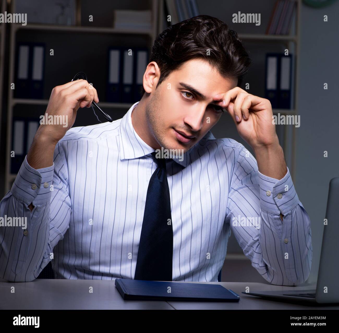 Tired and exhausted helpdesk operator during night shift Stock Photo ...