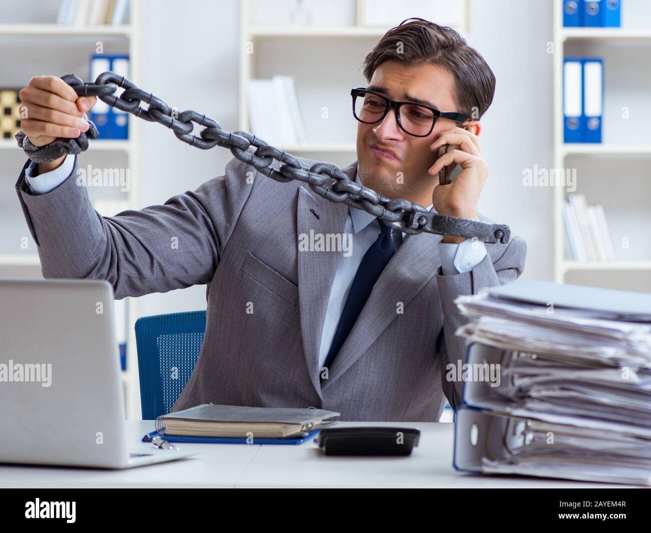 Man chained to desk hi-res stock photography and images - Alamy