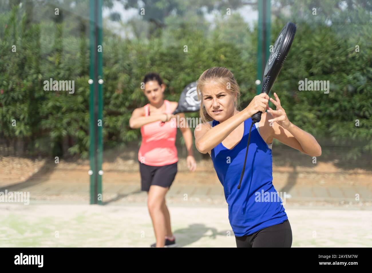 Blonde girl teaching correct paddle moves to a group of youngsters on ...