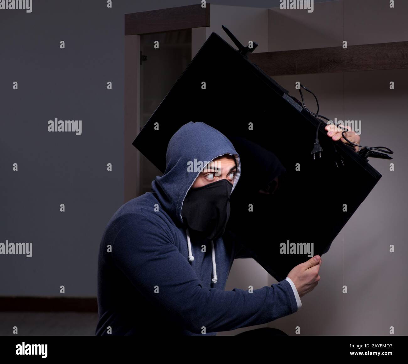 Burglar thief stealing tv from apartment house Stock Photo - Alamy