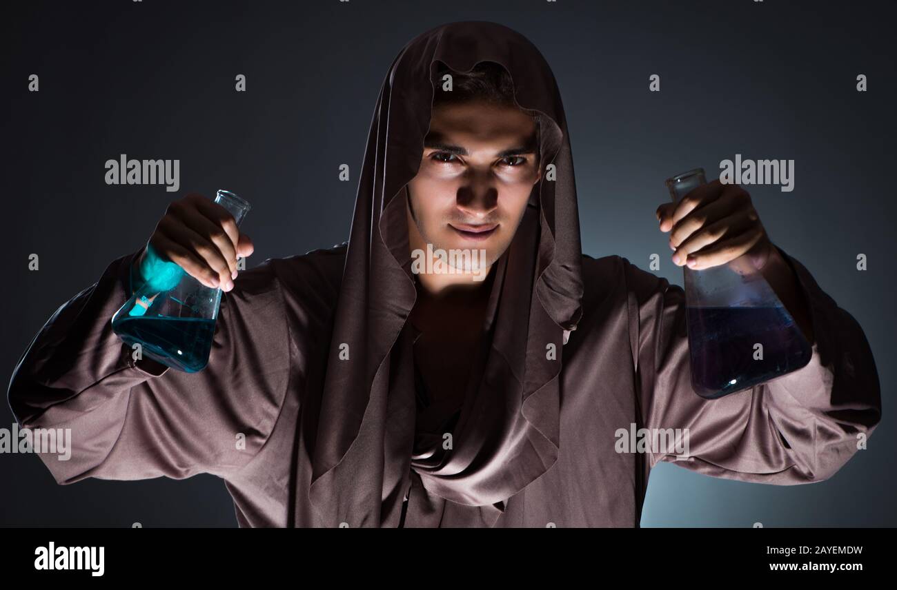Alchemist doing experiments in alchemy concept Stock Photo - Alamy