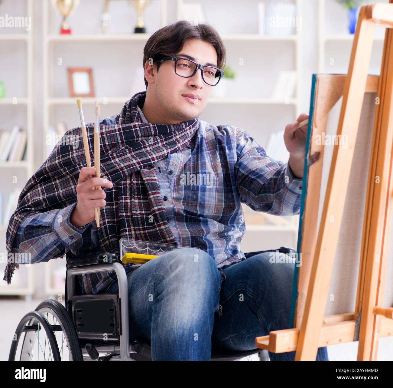 Disabled artist painting picture in studio Stock Photo - Alamy