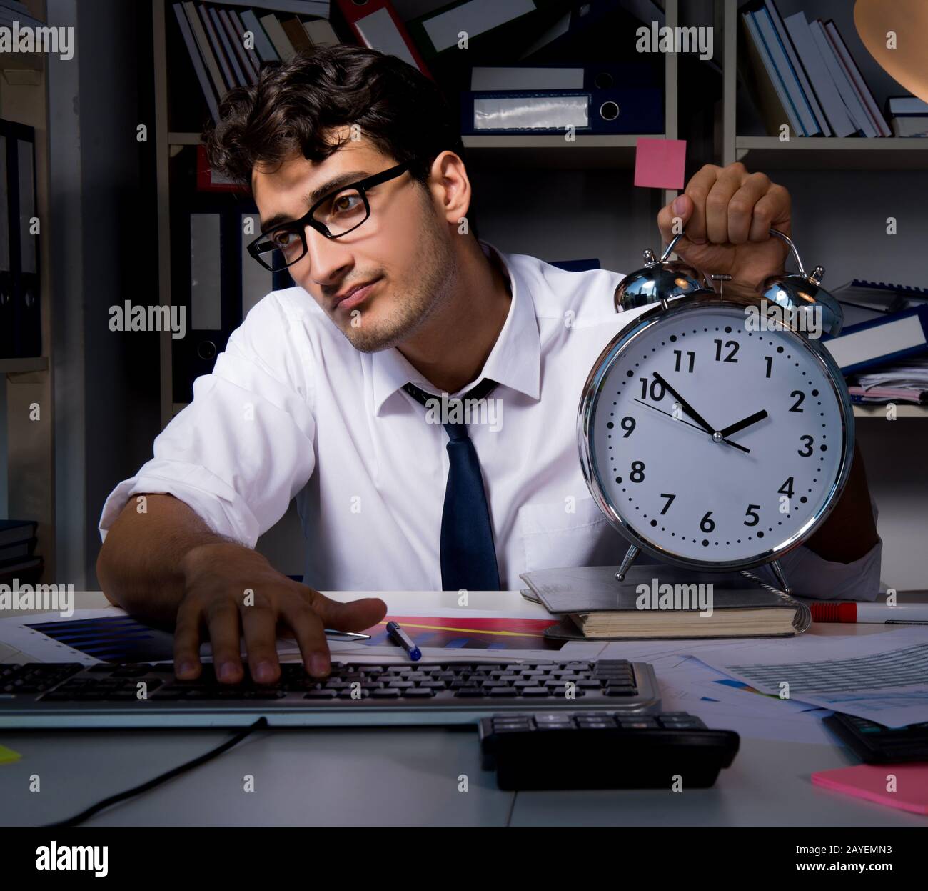 Man businessman working late hours in the office Stock Photo - Alamy