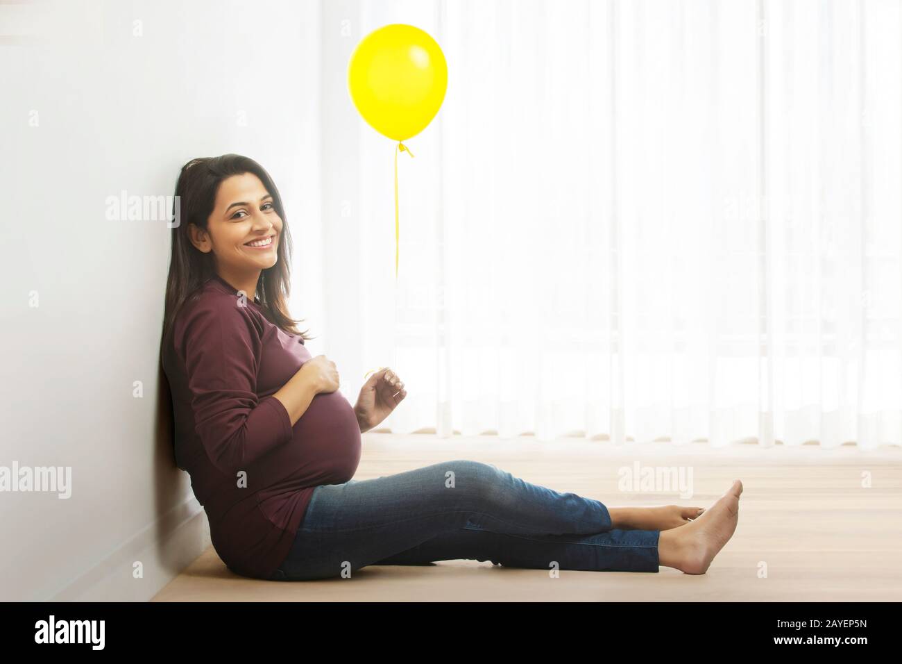 Woman with yellow balloon hi-res stock photography and images - Alamy