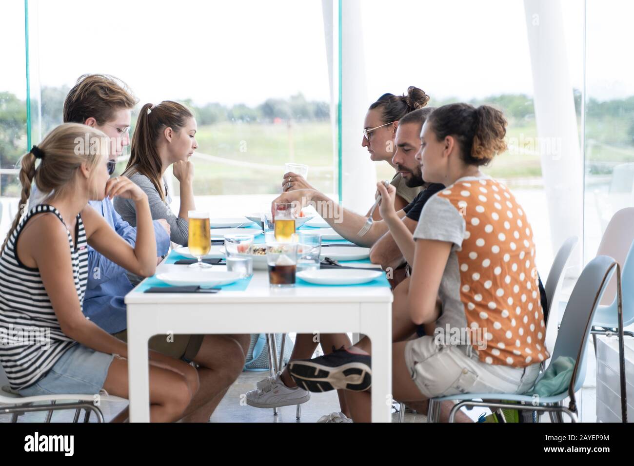 Group Of People Talking At Table Group Of Friends Sitting At Table In