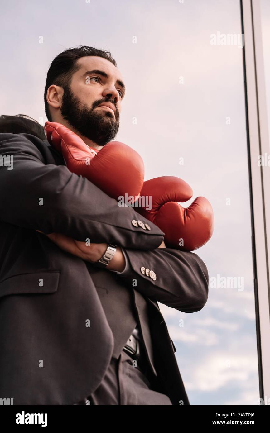 Vertical photo of a businessman in a suit with his arms crossed, with ...