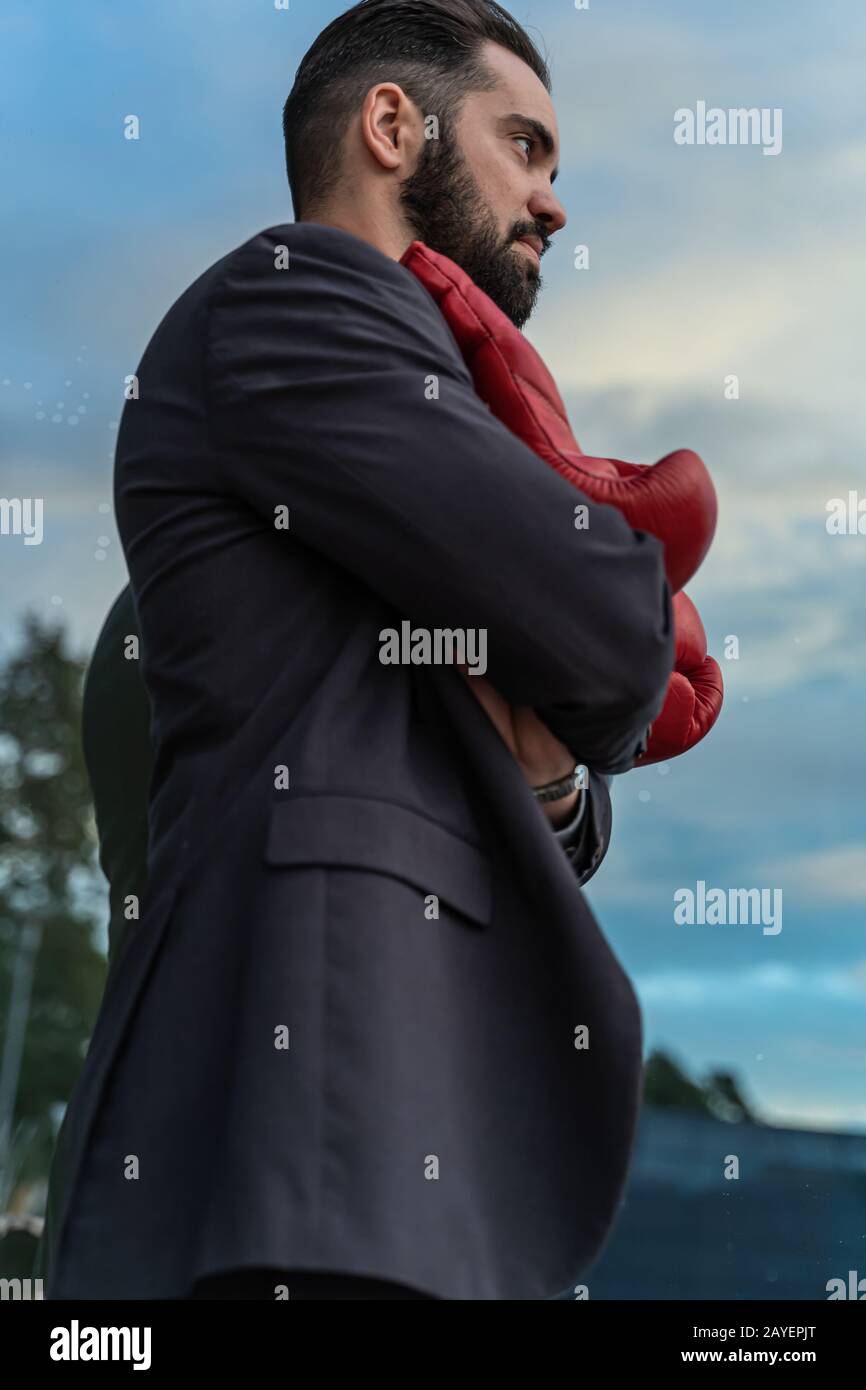 Vertical photo of the profile of a businessman in a suit with his arms ...