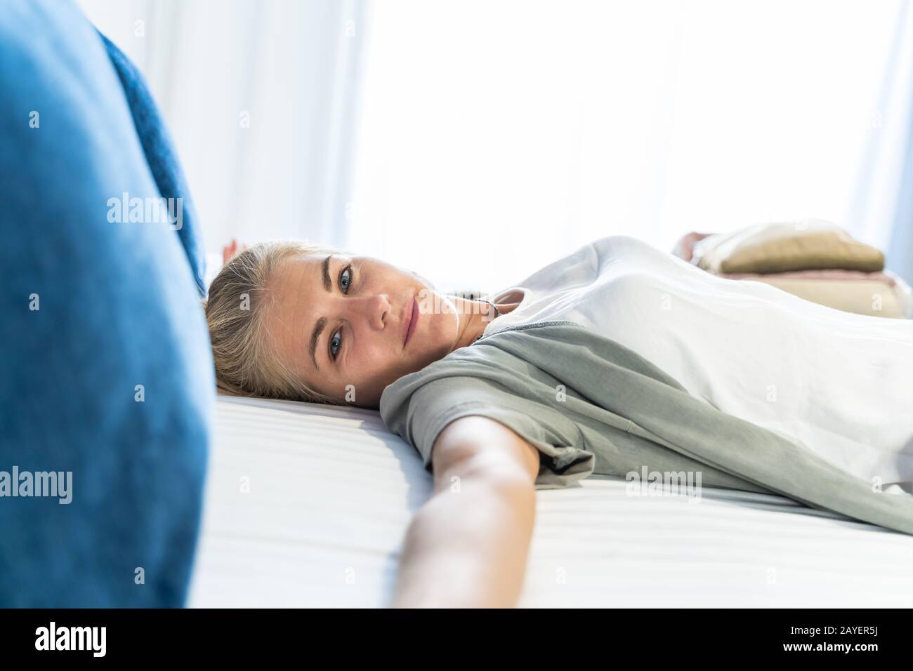 blonde girl lying in a hotel bed relaxing after her arrival Stock Photo ... blonde girl lying in a hotel bed relaxing after her arrival Stock Photo ...