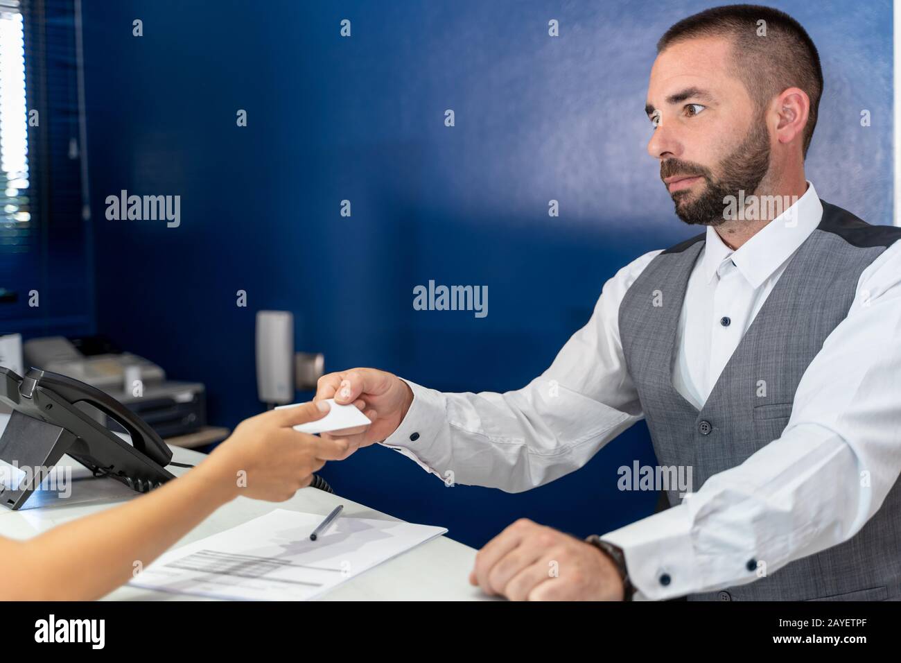 Stock photo of an hotel receptionist with friendly expression hand ...
